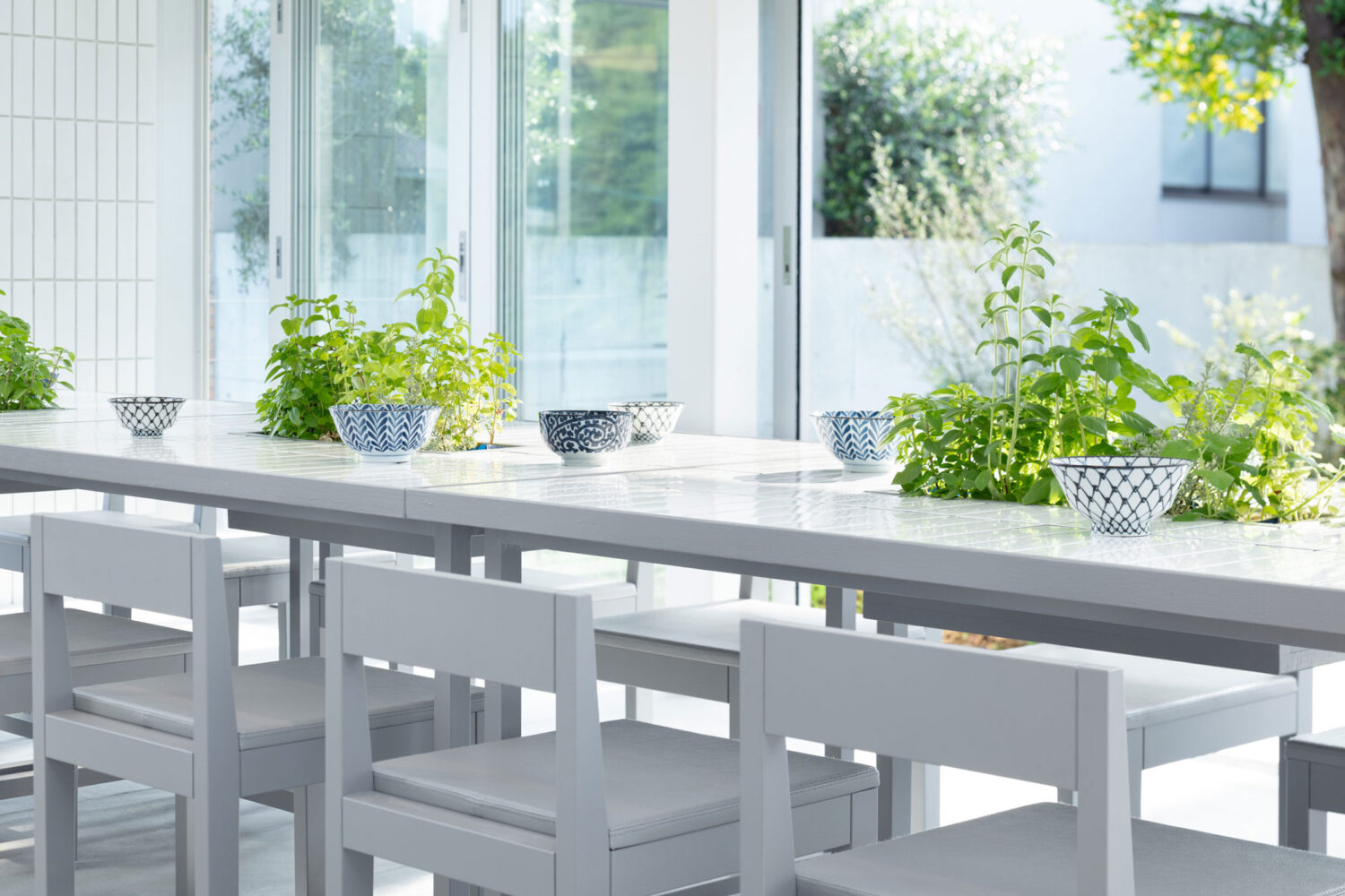 原田圭 / DO.DO.による、長崎・波佐見町の飲食店舗「COYANE SAIKAITOKI」。トンネル内壁用に開発された波佐見焼のタイルを採用し、建築外装・内装・家具に至るまで使用 ...