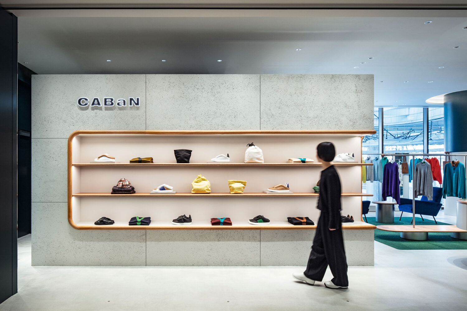 トラフ建築設計事務所による、東京・港区の店舗「CABaN AZABUDAI」。麻布台ヒルズの中の広場を見渡せる角の区画。眼前の風景を活かす為、諸機能をコンパクトにまとめて開口部の前に“大きな ...