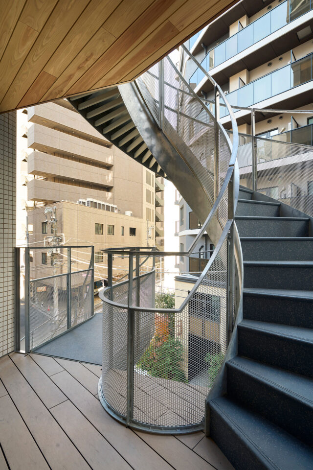 大野力 / sinatoによる、東京・千代田区の「12 KANDA」。パブリックな用途も含むシェアオフィス。個室群の“街への対峙”も意図し、屋外避難階段を表側でバルコニーと繋げて“日常動線”に ...